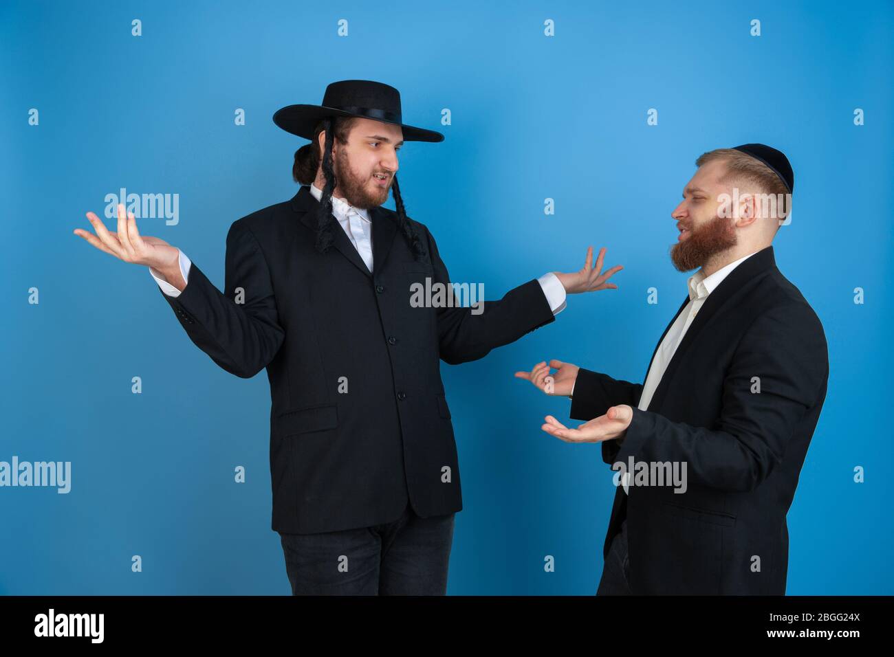 Pointing, greeting. Portrait of a young orthodox jewish men isolated on ...