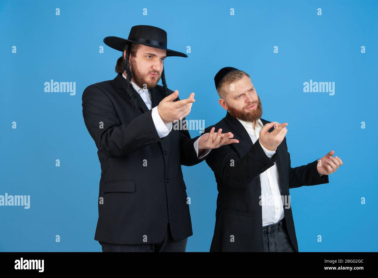 Pointing, asking. Portrait of a young orthodox jewish men isolated on ...