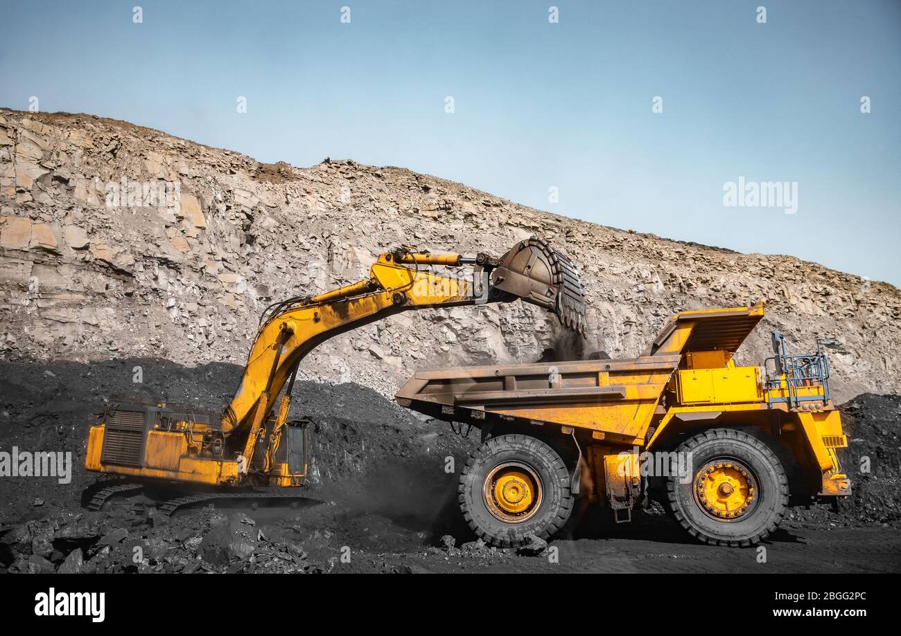Coal loading at open mining site yellow truck industry Stock Photo - Alamy
