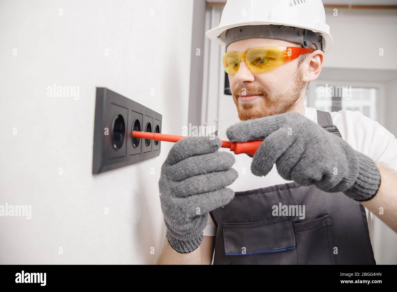 Electrician install switches and sockets screwdriver tool working at ...