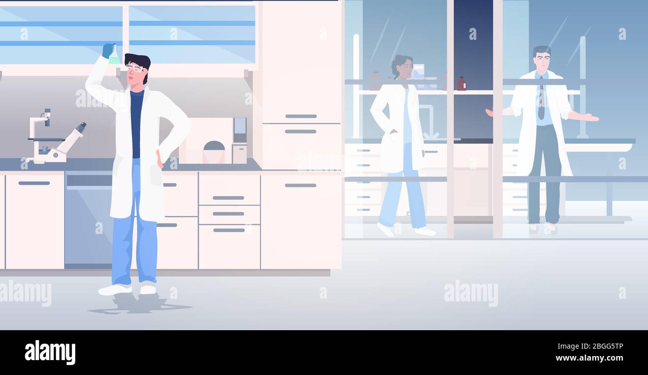scientist working in medical lab researchers in white coats making ...