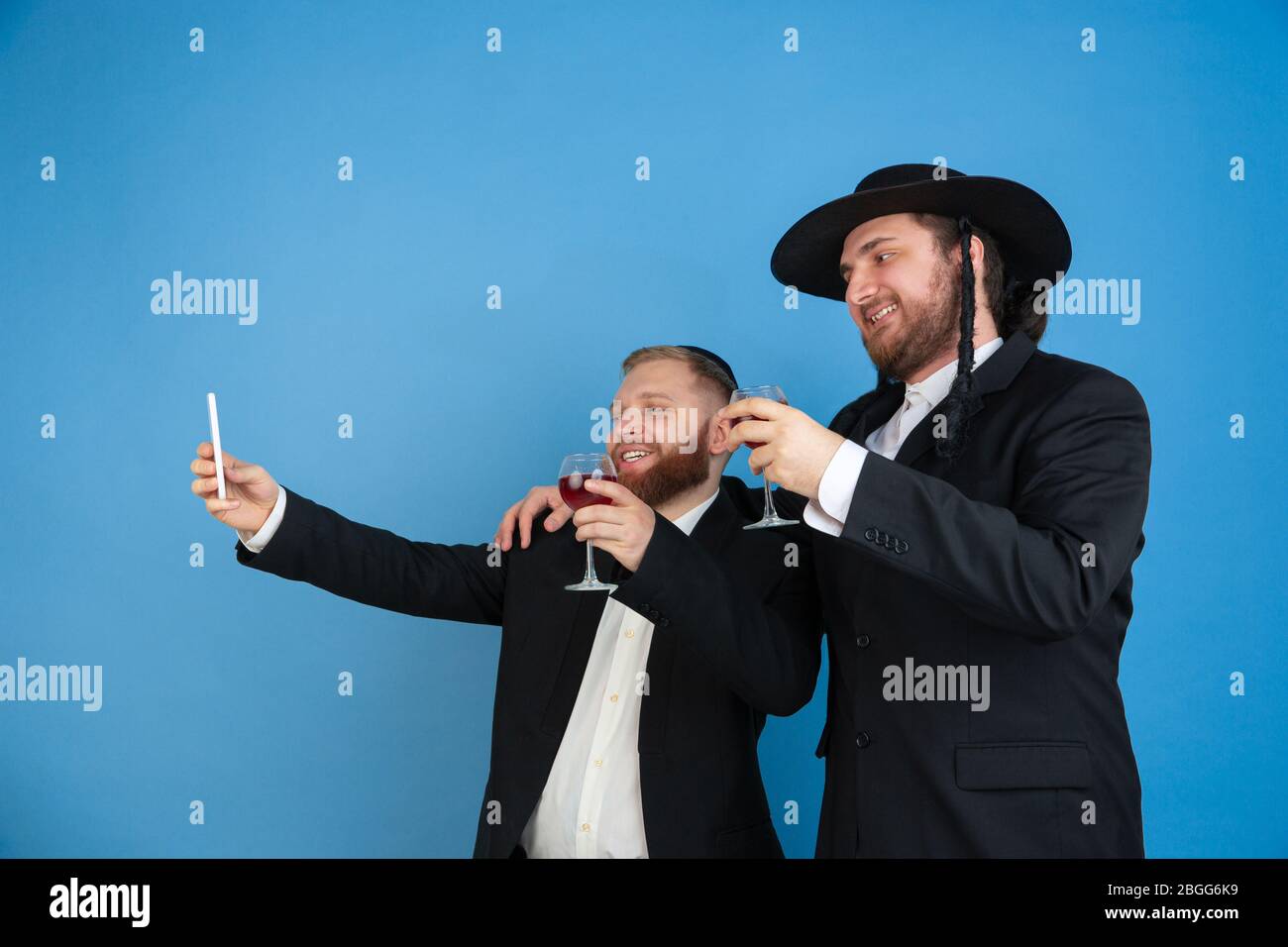 Taking selfie with wine. Portrait of a young orthodox jewish men ...