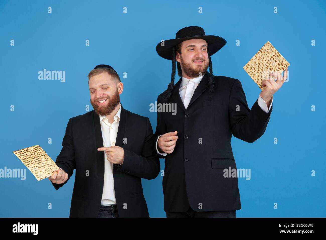 Eating matzah, inviting. Portrait of a young orthodox jewish men ...