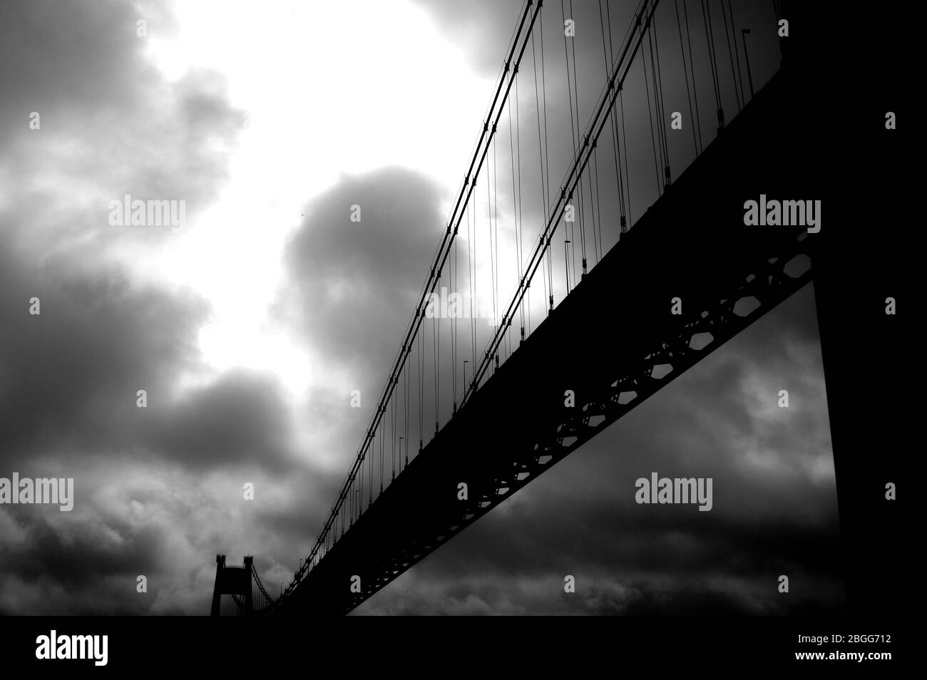 Large suspension bridge spanning a wide river Stock Photo - Alamy