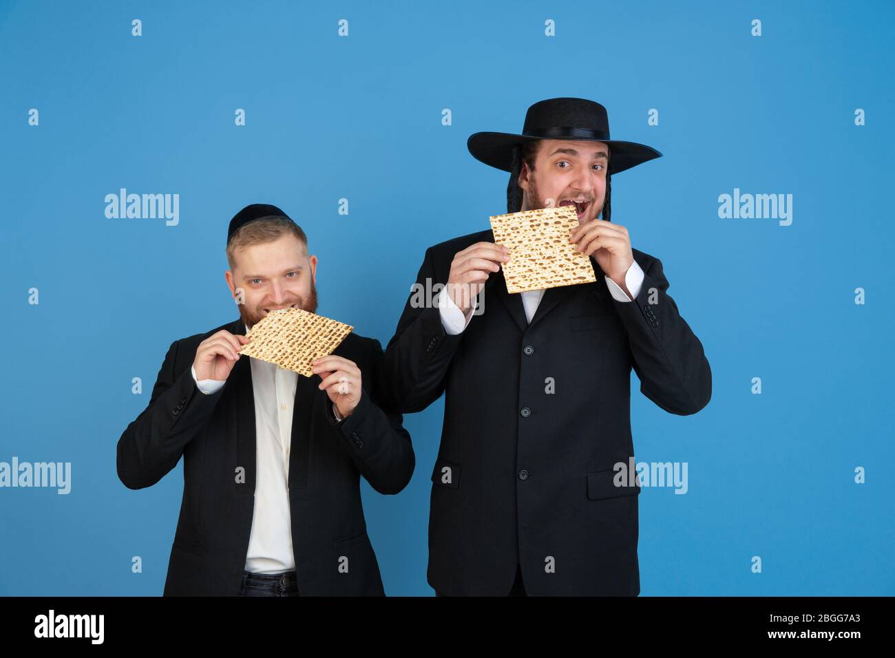 Eating matzah, inviting. Portrait of a young orthodox jewish men ...