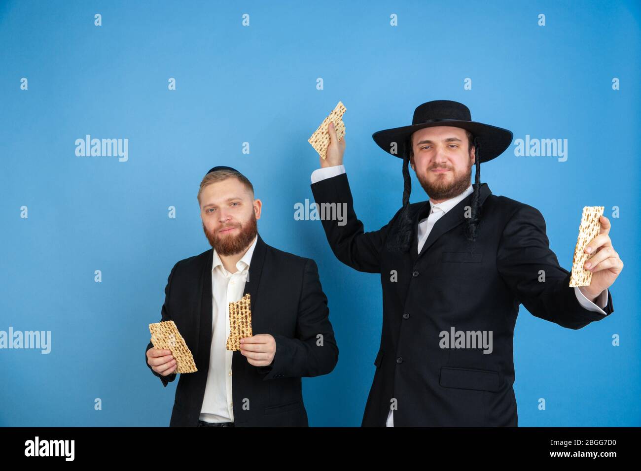 Eating matzah, inviting. Portrait of a young orthodox jewish men ...