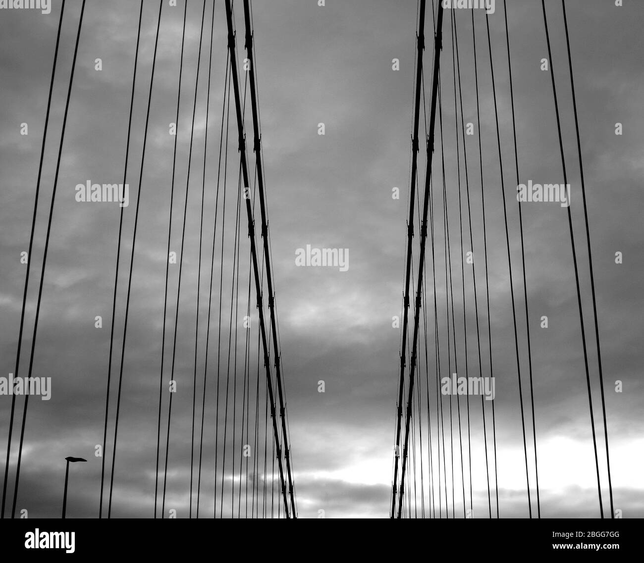 Large suspension bridge spanning a wide river Stock Photo - Alamy