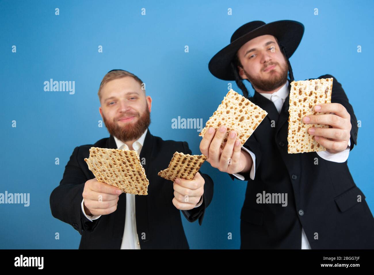 Eating matzah, inviting. Portrait of a young orthodox jewish men ...