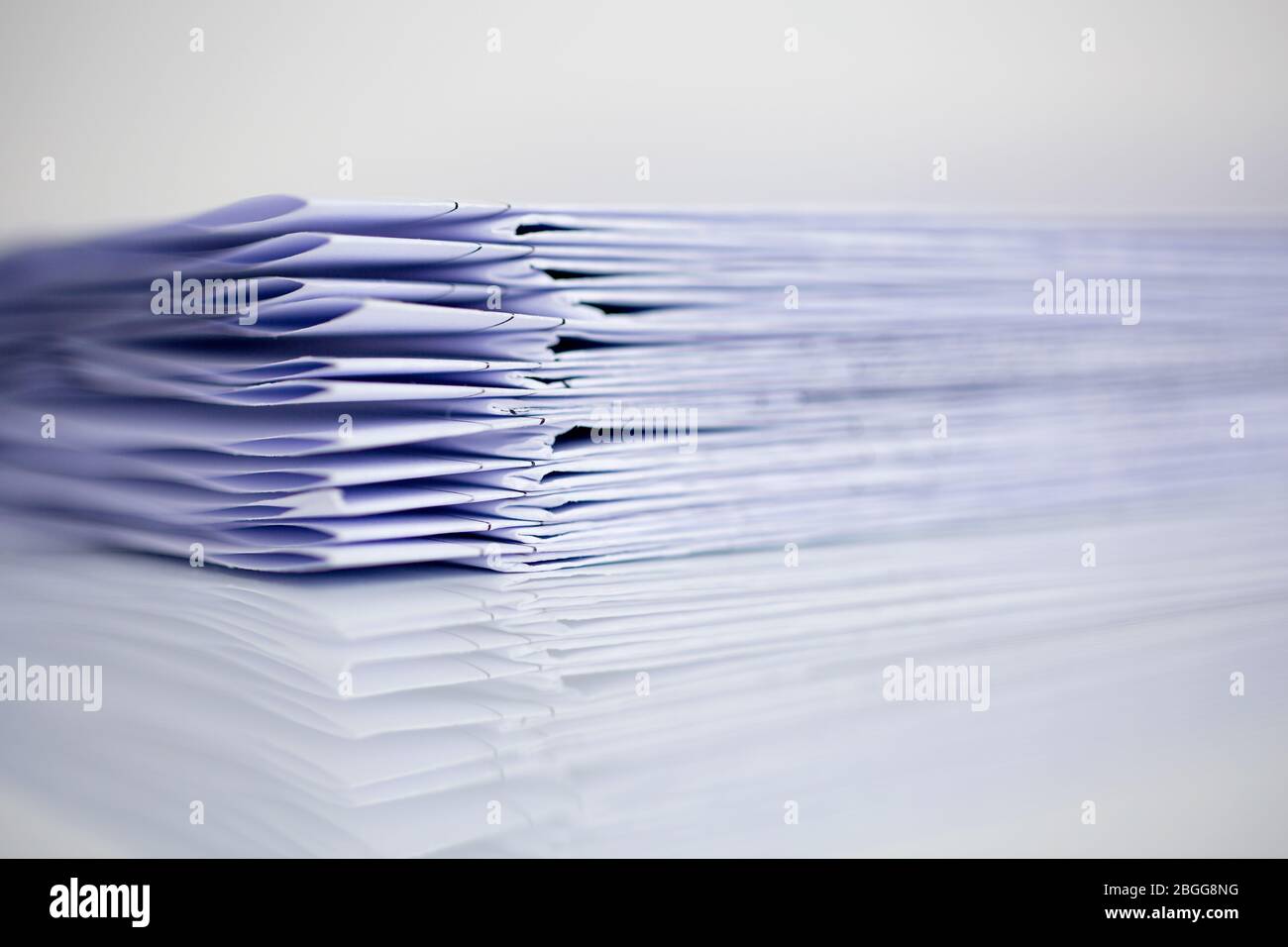 Stack Folding drawings on a blue background. Copy space Stock Photo - Alamy
