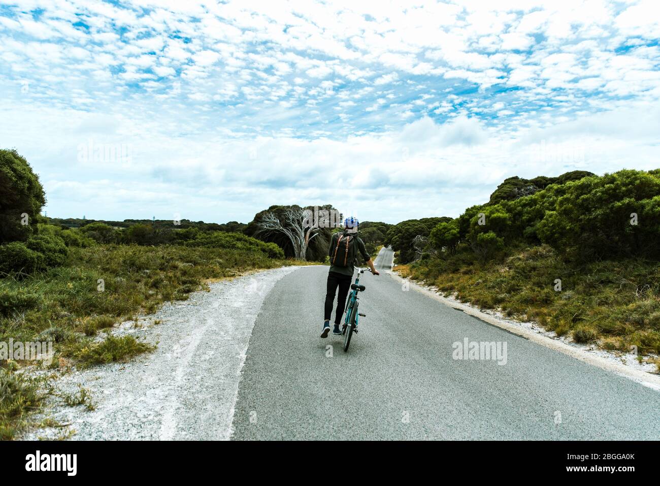 Man tourist riding a bike on Rottnest Island, Western Australia ...