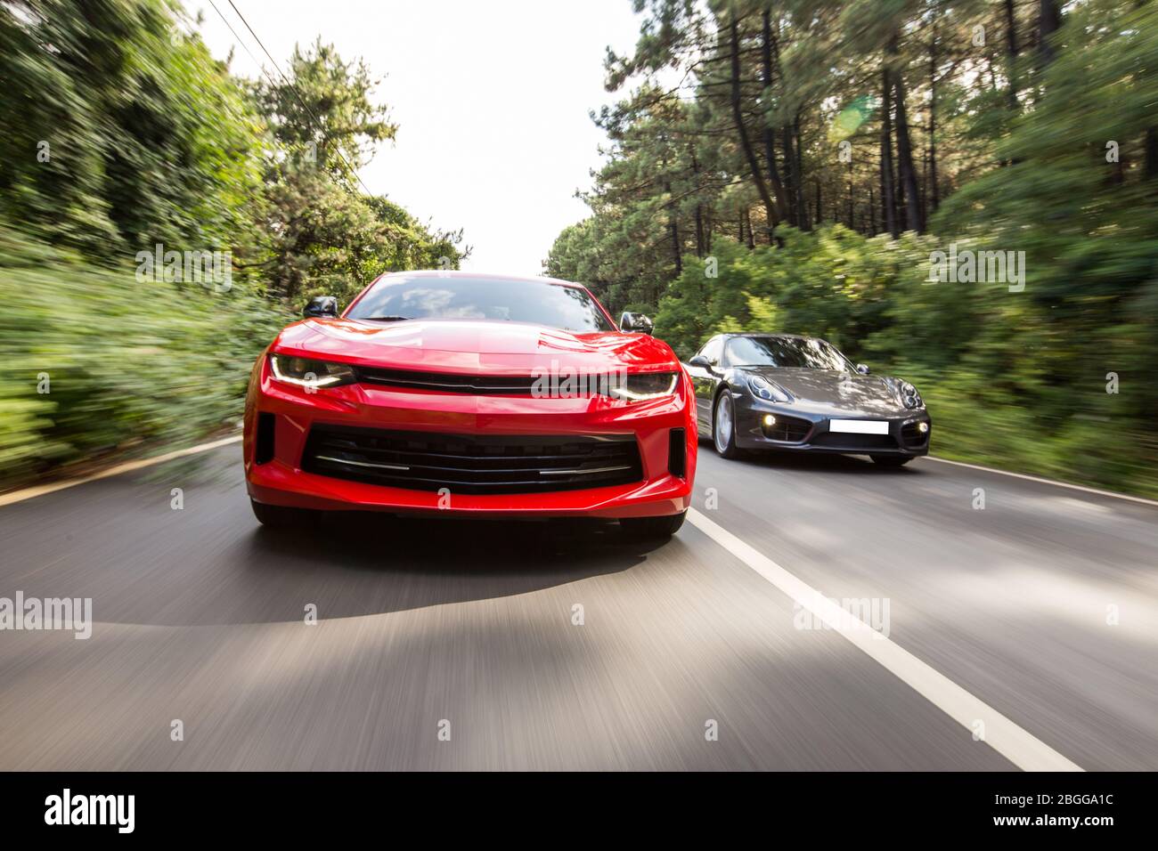 Red and black sport cars chasing each other Stock Photo - Alamy