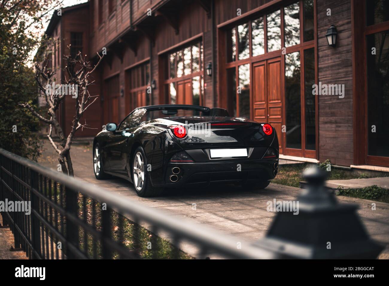 Black modern car in the yard in front of a building Stock Photo - Alamy