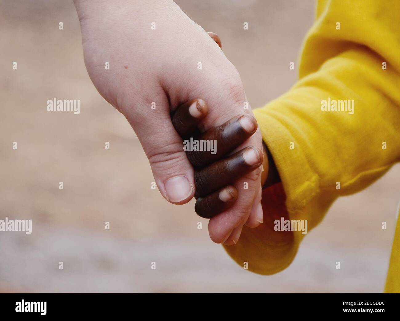 Close-up photo of African and Caucasian Hands Holding Together as a ...