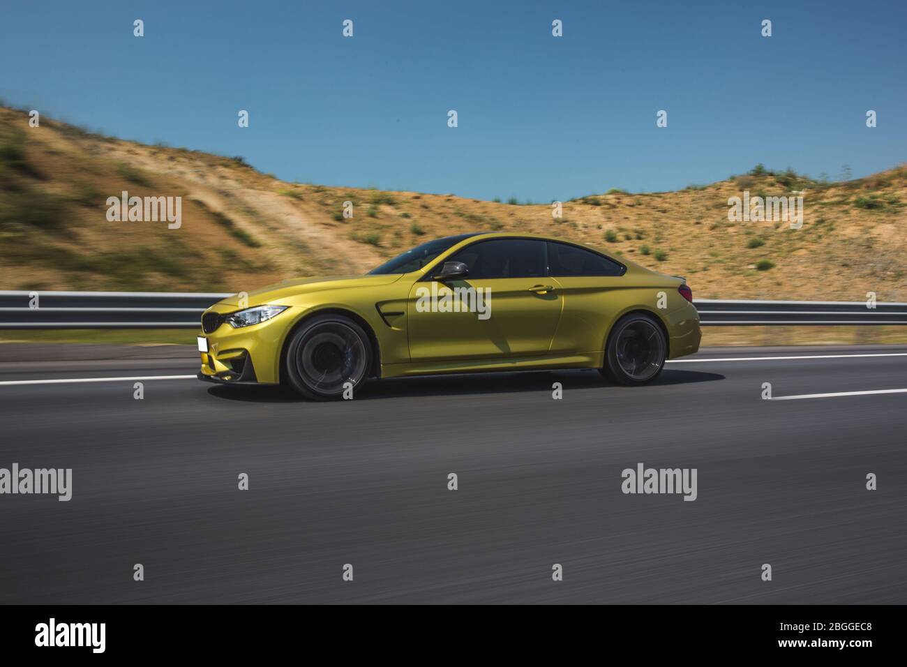 Yellow racecar on the highway across deserts Stock Photo - Alamy