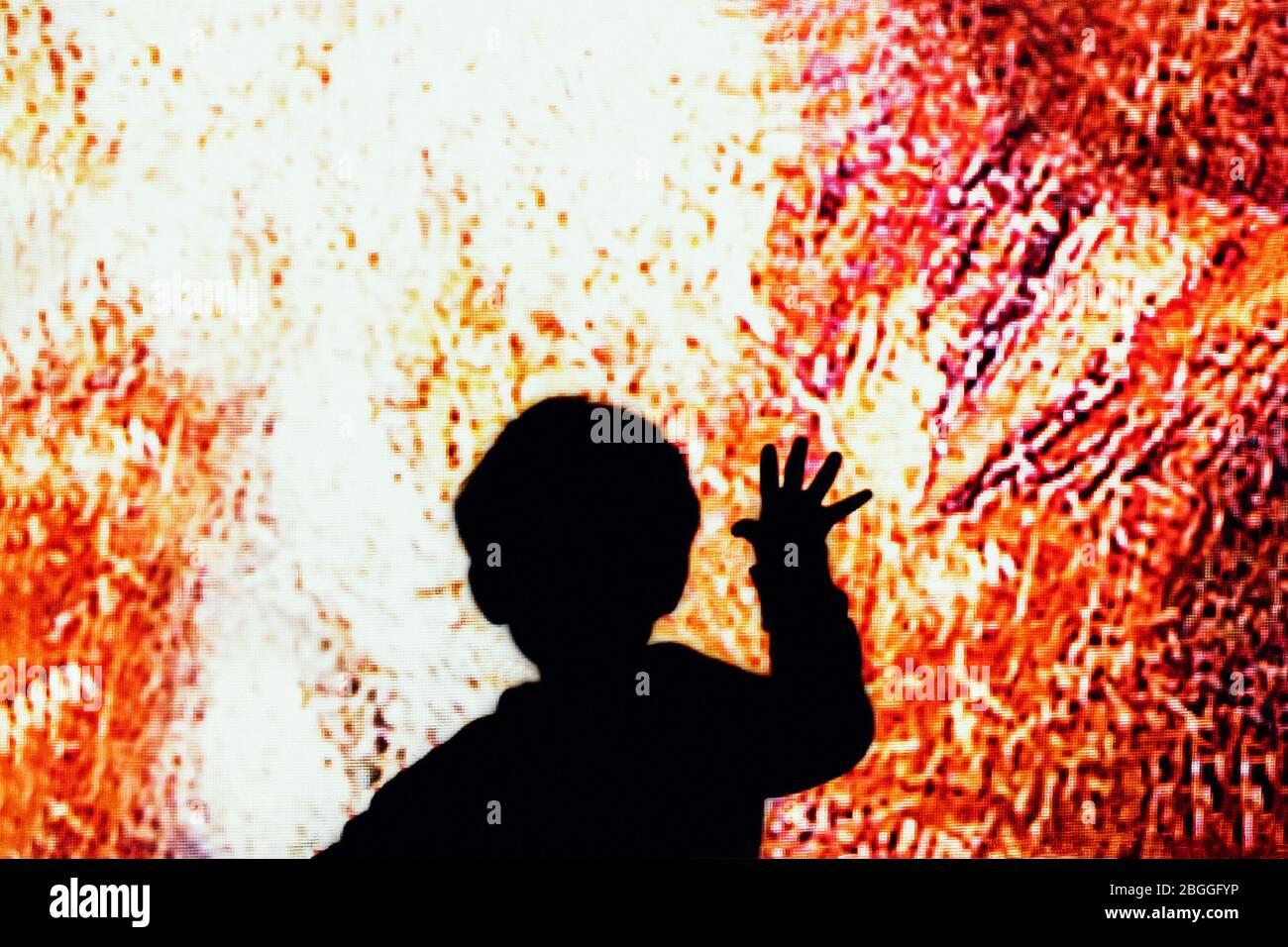 Child touch the big screen. Child hand touches on the glass. Black and ...