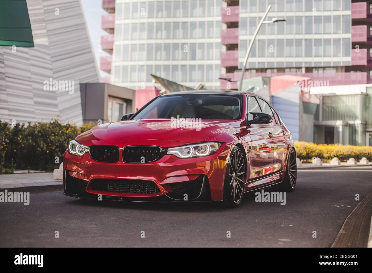 Red model sedan in the landmark parking, across business residences ...