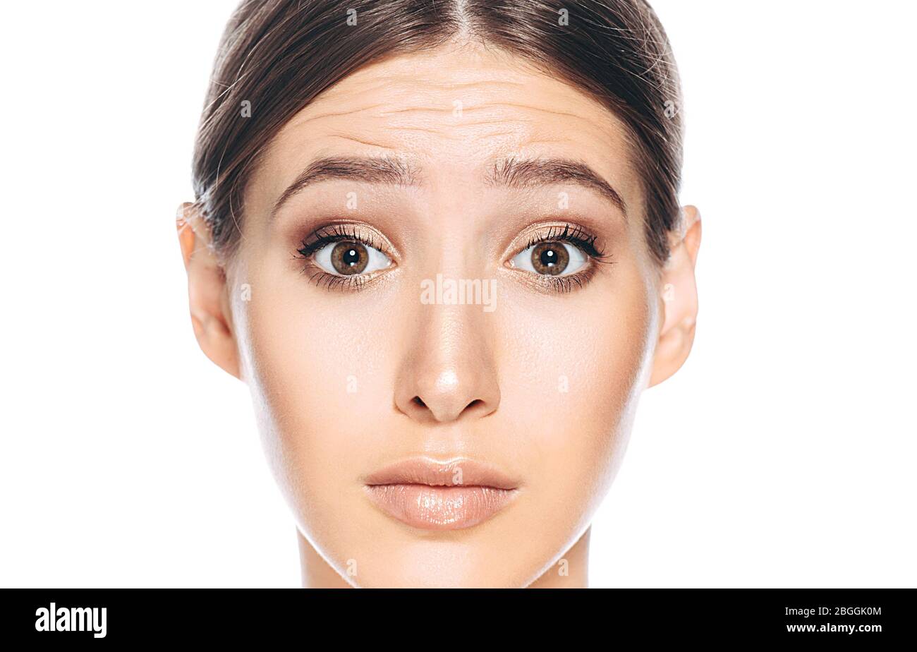 Surprised face of a beautiful woman. Forehead wrinkles Stock Photo - Alamy