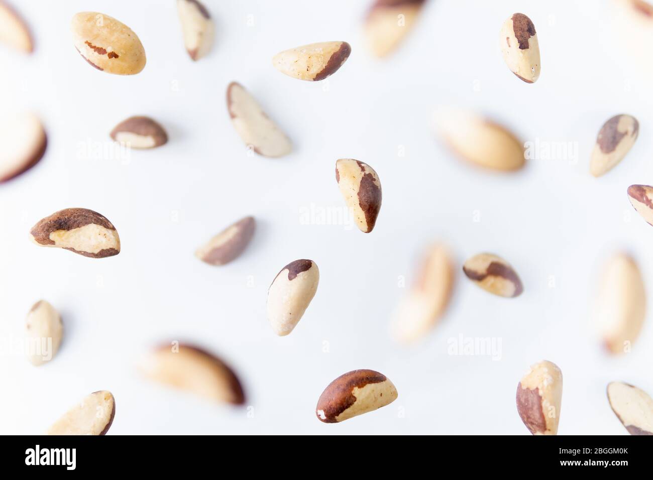 Shelled Brazilian nuts flying above white background, levitation effect ...