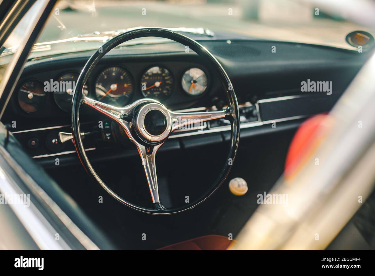 Control wheel and speedometer system of a retro car, view through ...