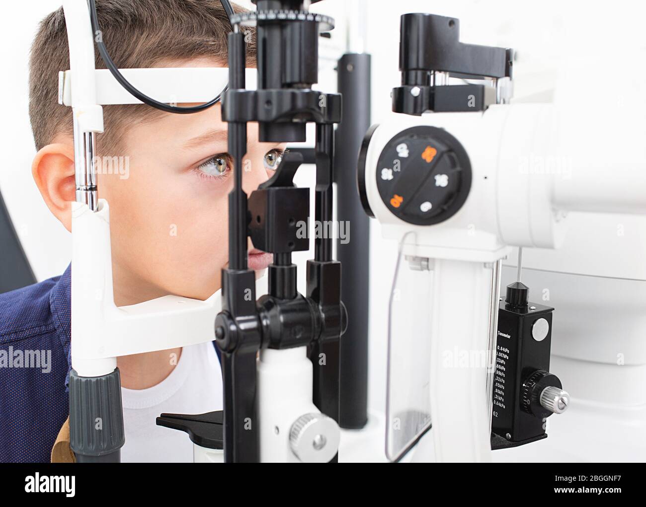 Boy's eyesight test with binocular slit-lamp. Checking retina of a ...