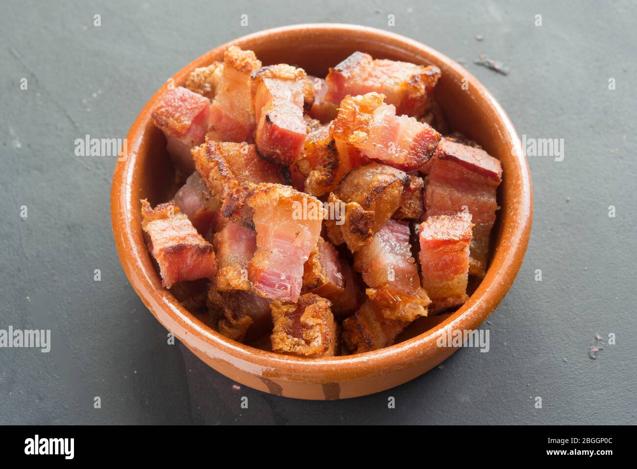 slice of bacon tapa typical spanish food Stock Photo - Alamy