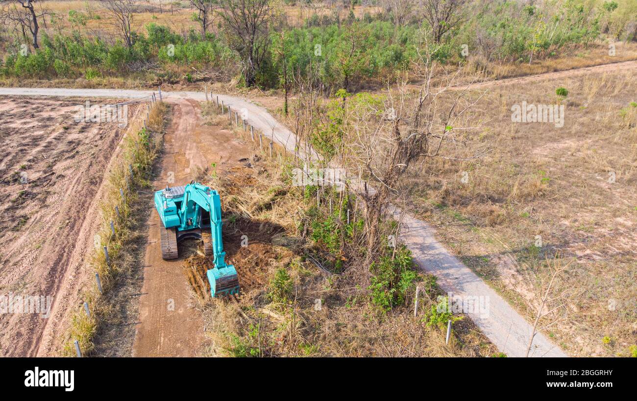 Backhoe is working in the garden Stock Photo - Alamy