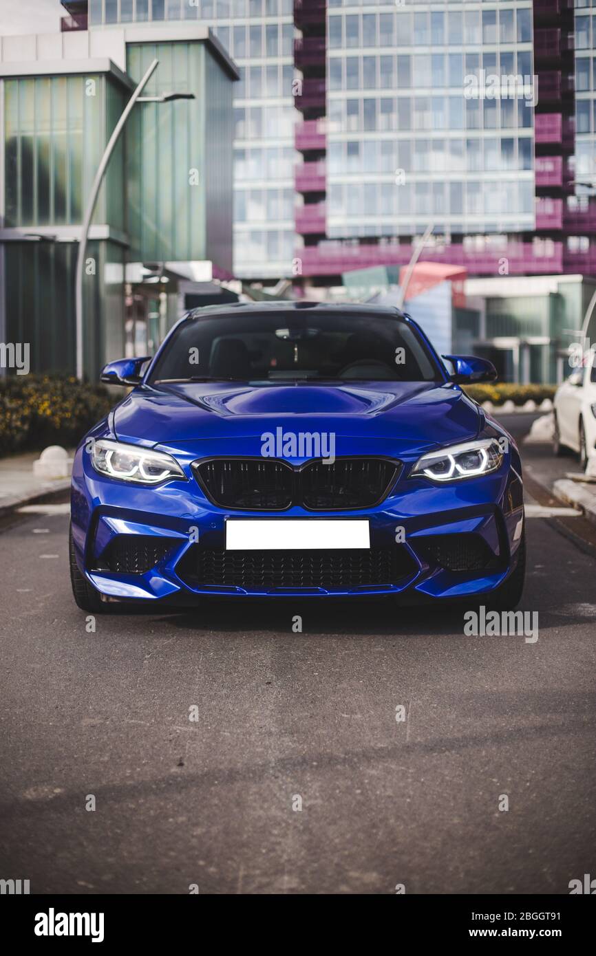 Blue design racing car parking outside of a business building Stock ...