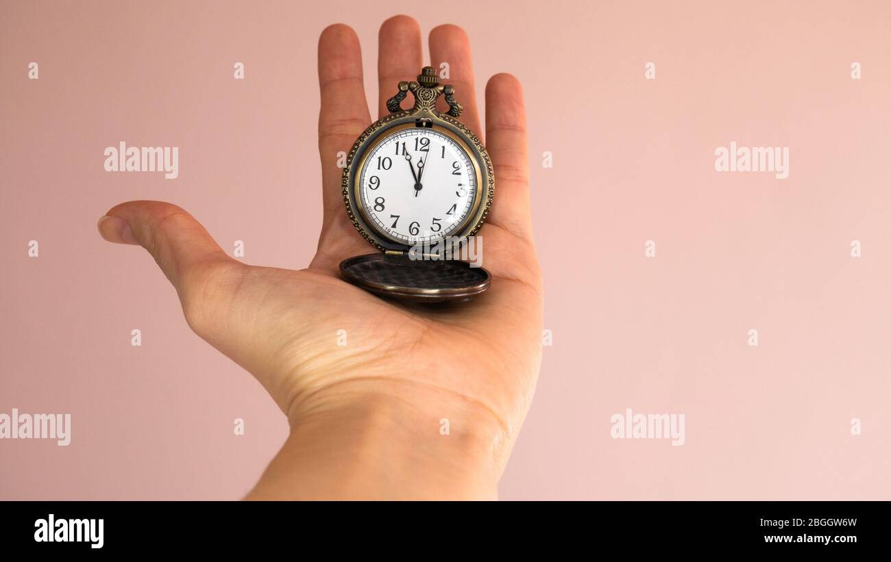 Old pocket watch in young woman's hand. Negative space Stock Photo - Alamy