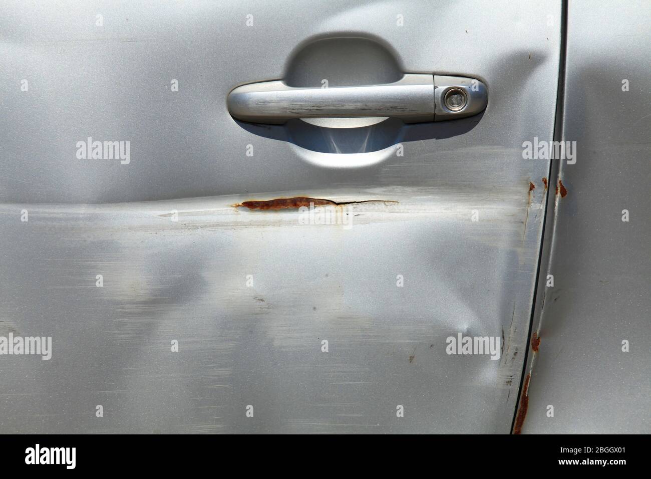 Fragment of a dented and broken door of a passenger car. Accident or ...