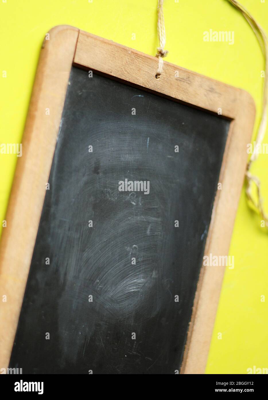 empty vintage chalkboard with yellow background Stock Photo - Alamy