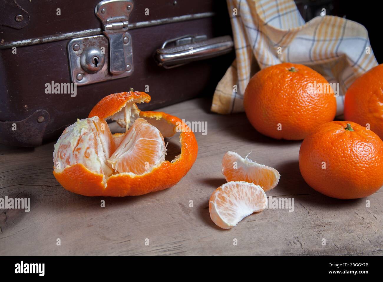 Several of unpeeled whole fresh orange mandarine or oranges, tangerines ...