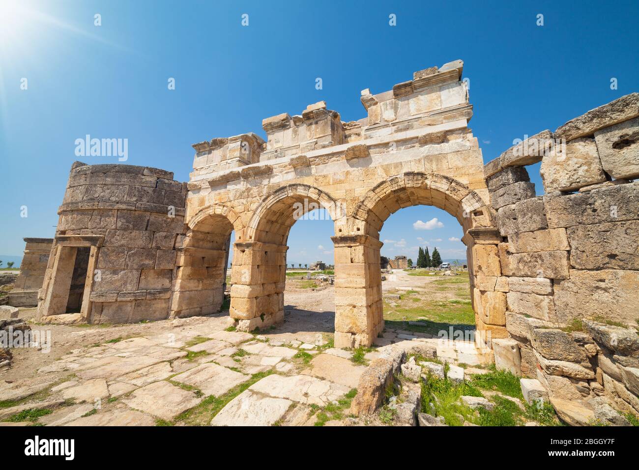 Wide angle view of triple arch Gate of Domitian in Hierapolis ancient ...