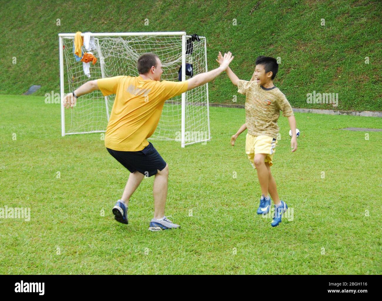 High-five during soccer game Stock Photo - Alamy