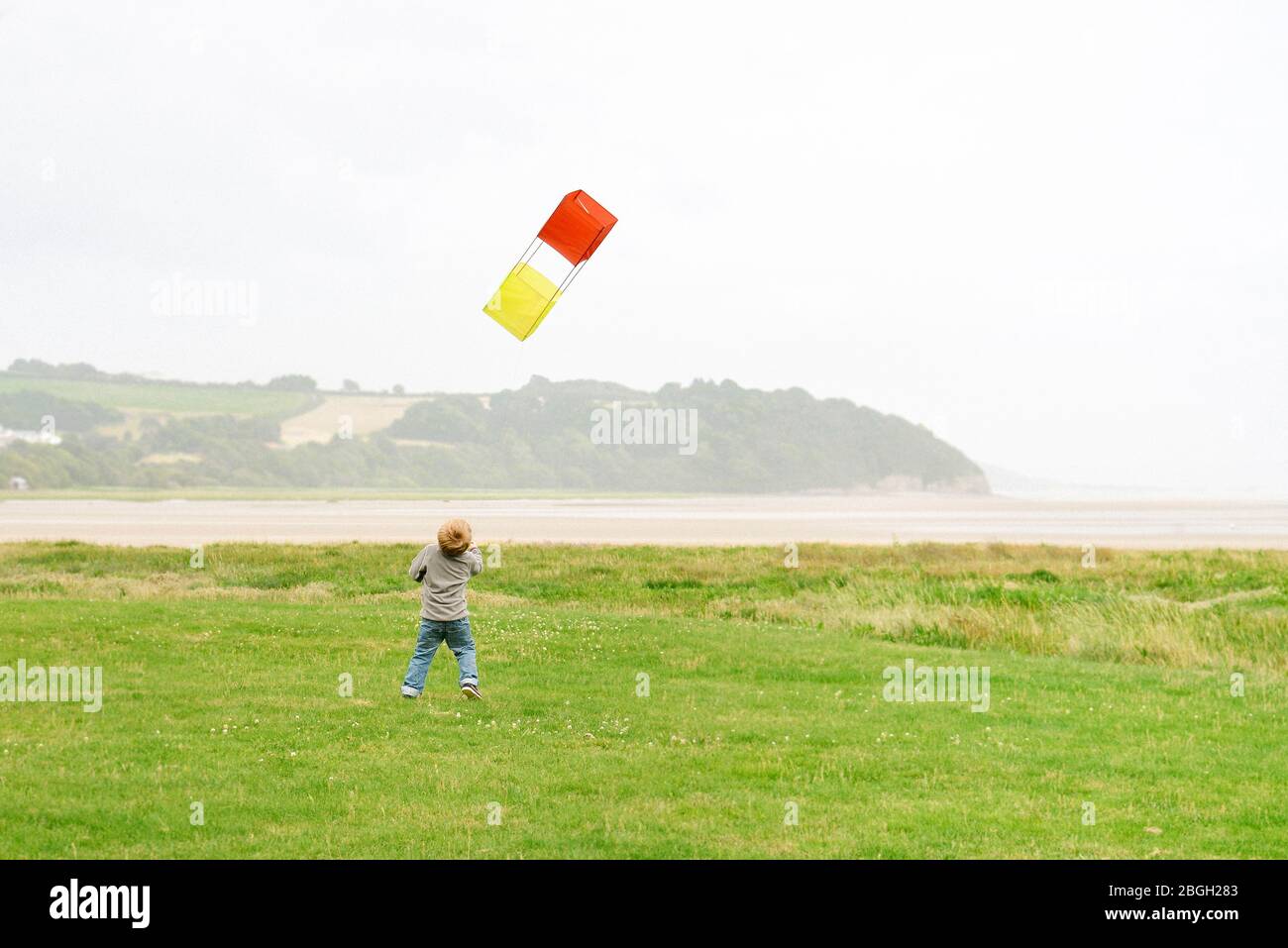 Young Boy Flying Kite Stock Photo - Alamy