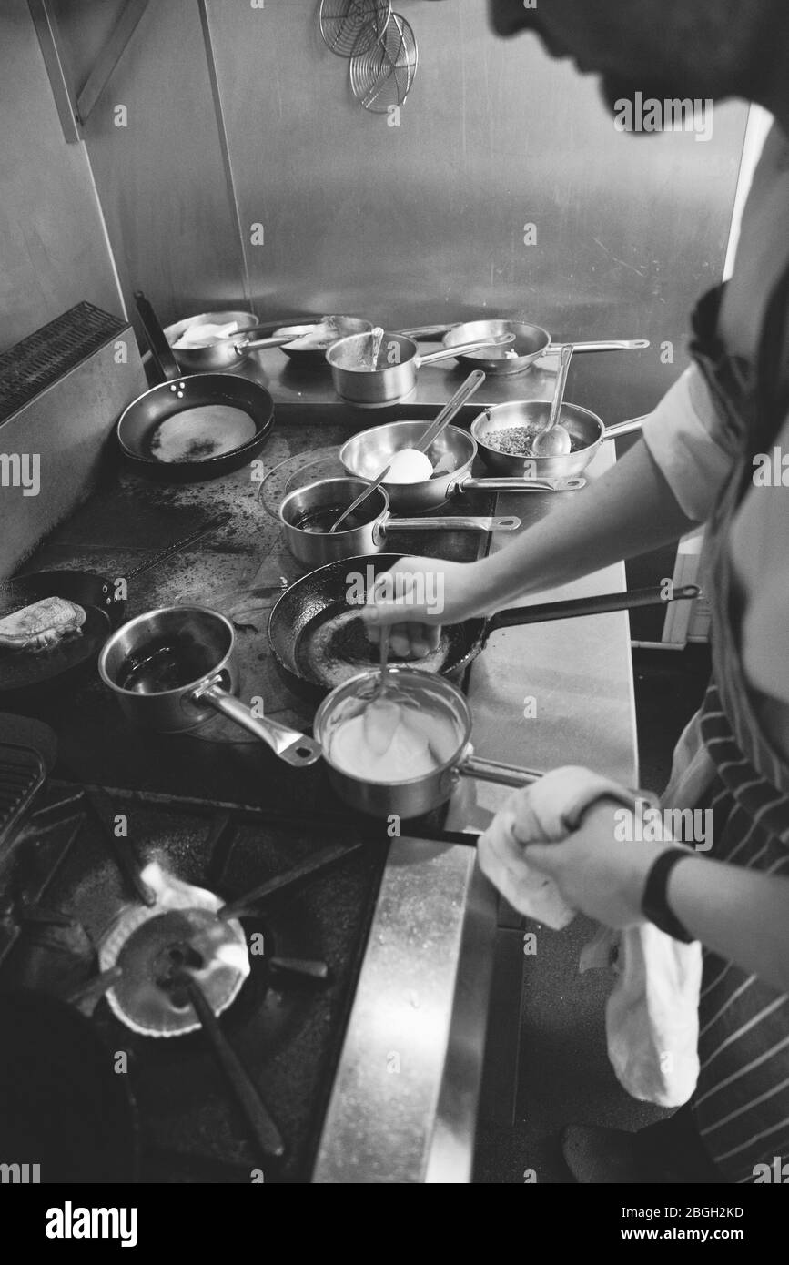 Person stirring food in pan hi-res stock photography and images - Alamy