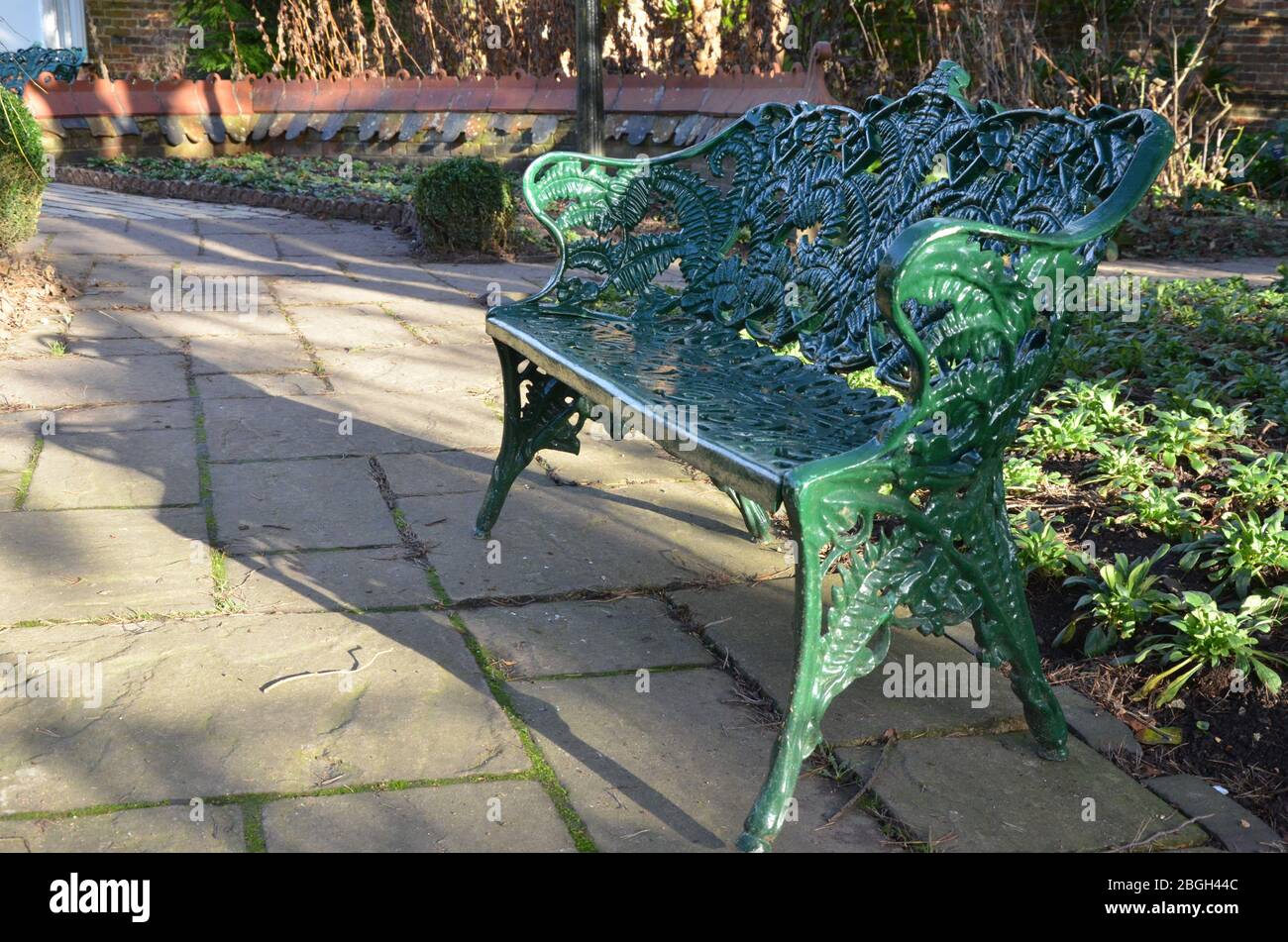 Beautiful green bench with leaves design Stock Photo - Alamy