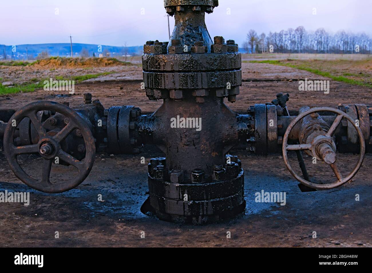 Horizontal view of a wellhead with valve fittings. Oil and gas industry ...