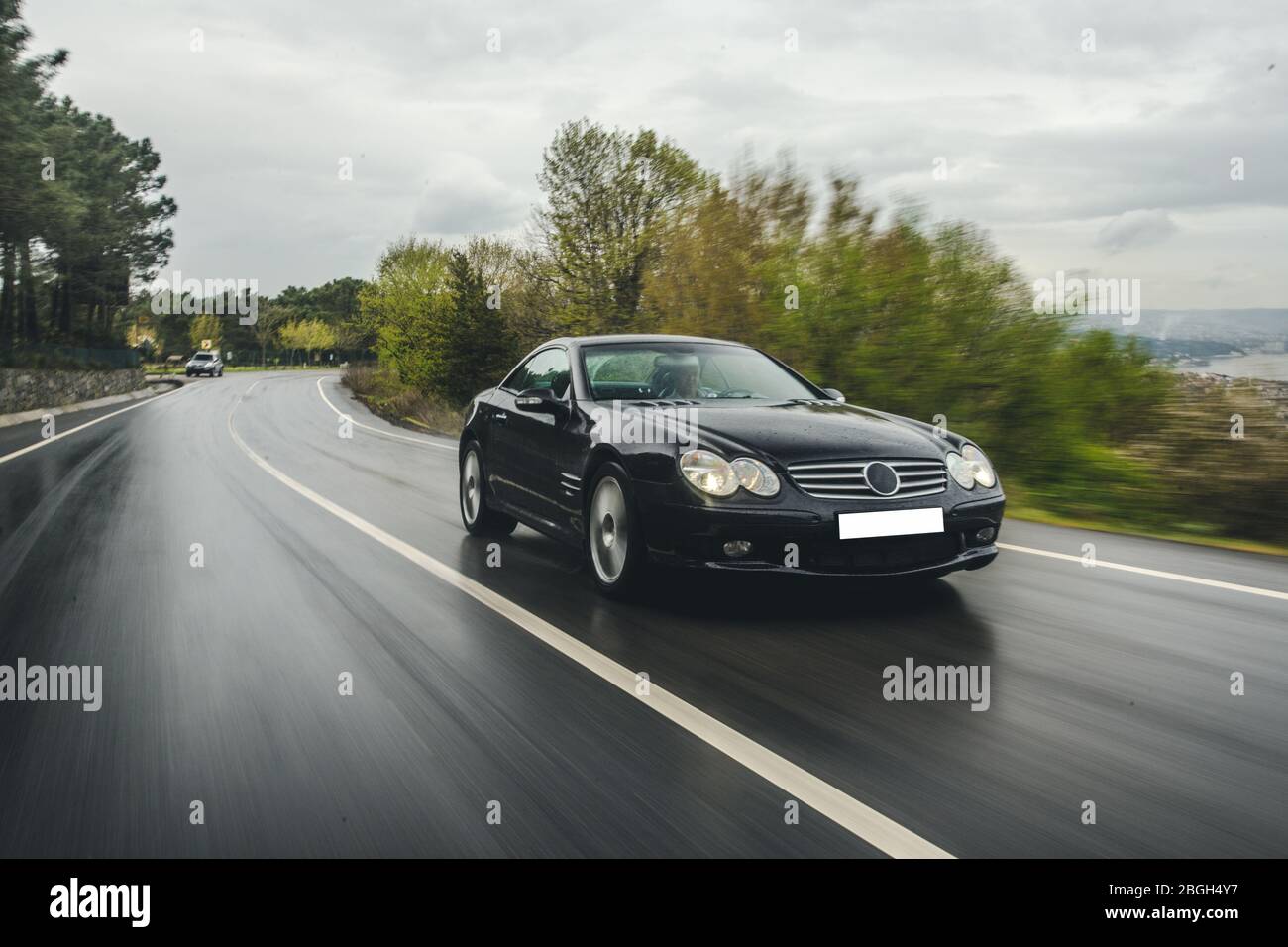 Black old model sedan in the rainy highway Stock Photo - Alamy