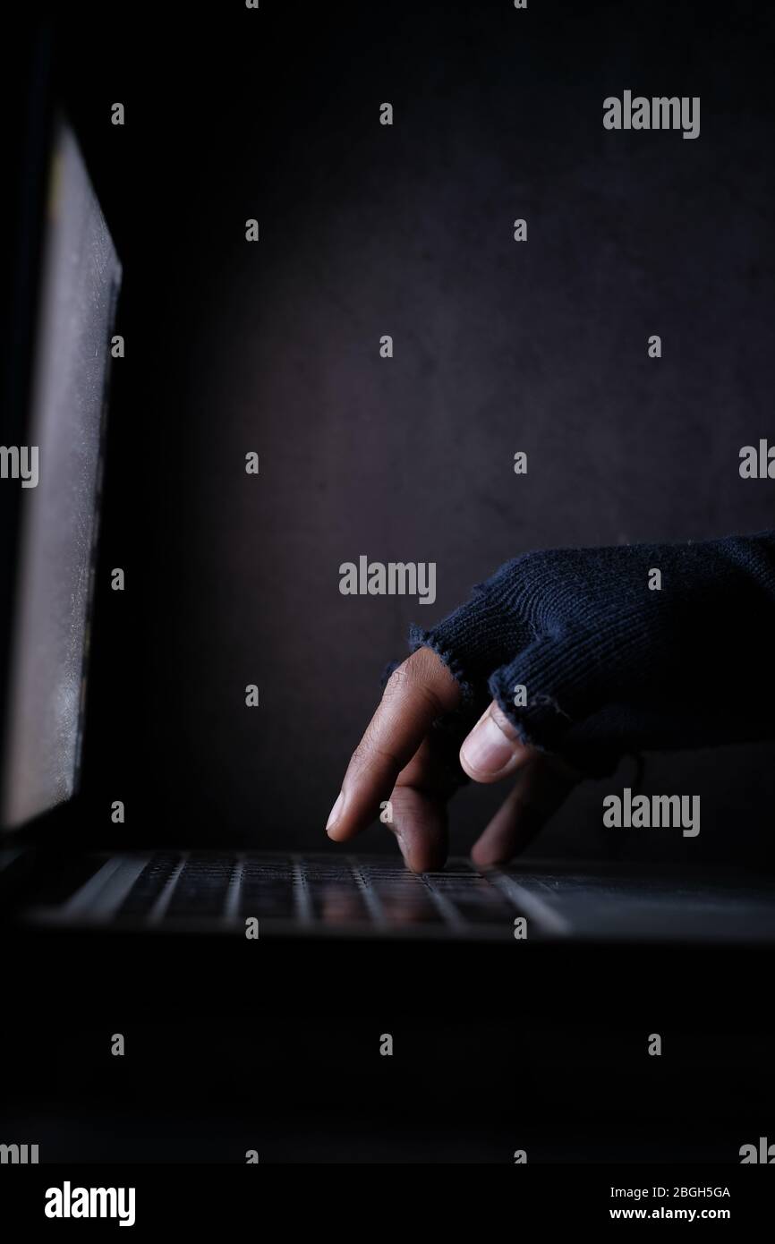 Close up of hacker hand stealing data from laptop Stock Photo - Alamy