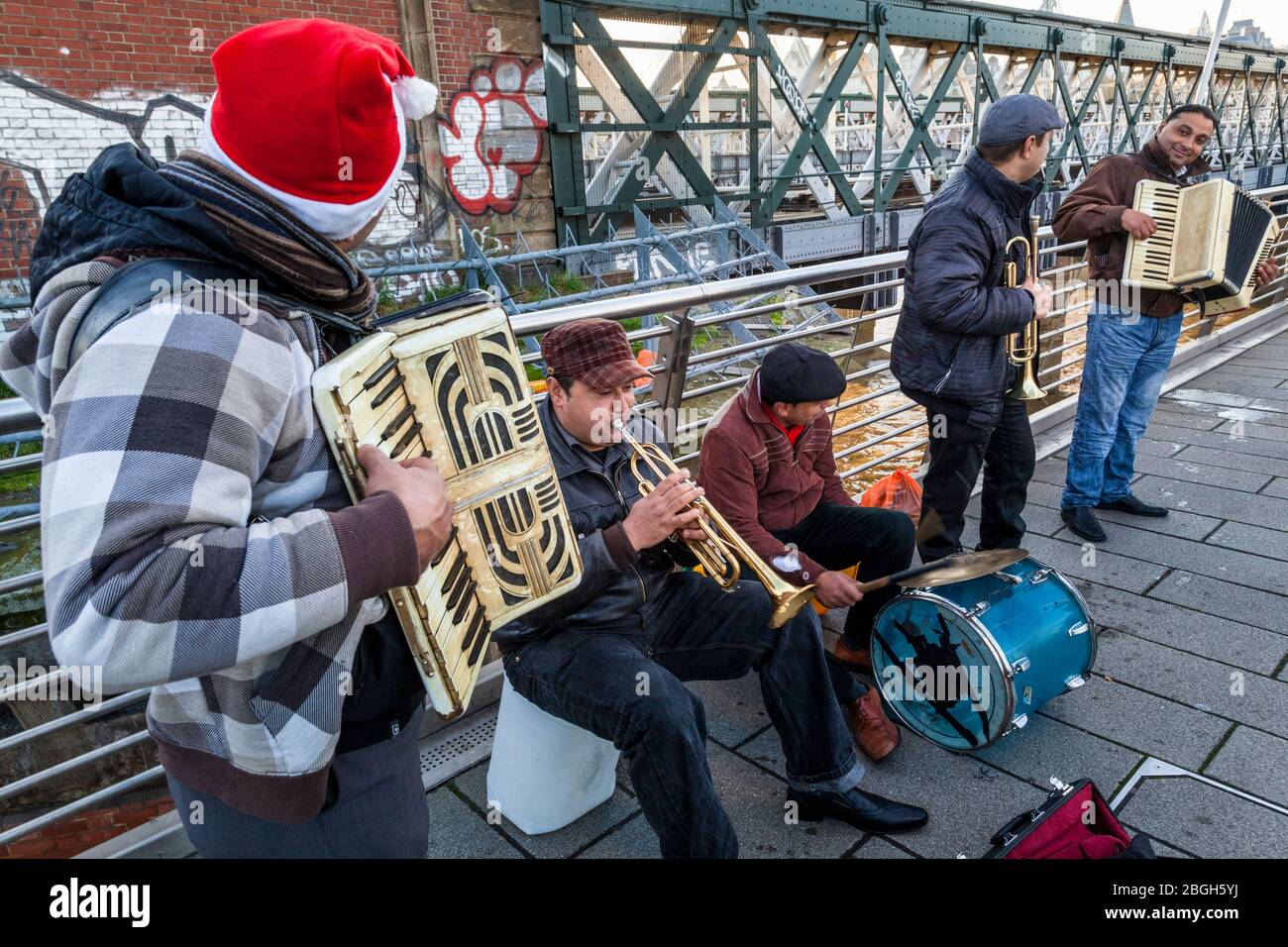 Group of musicians busking outside. Buskers playing music on accordions ...