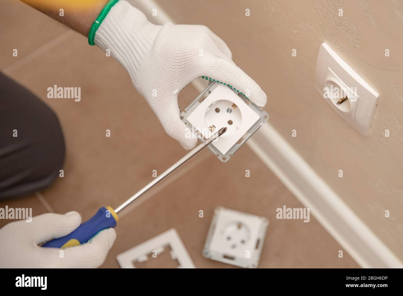 Electrician builder install working switches and sockets black color ...