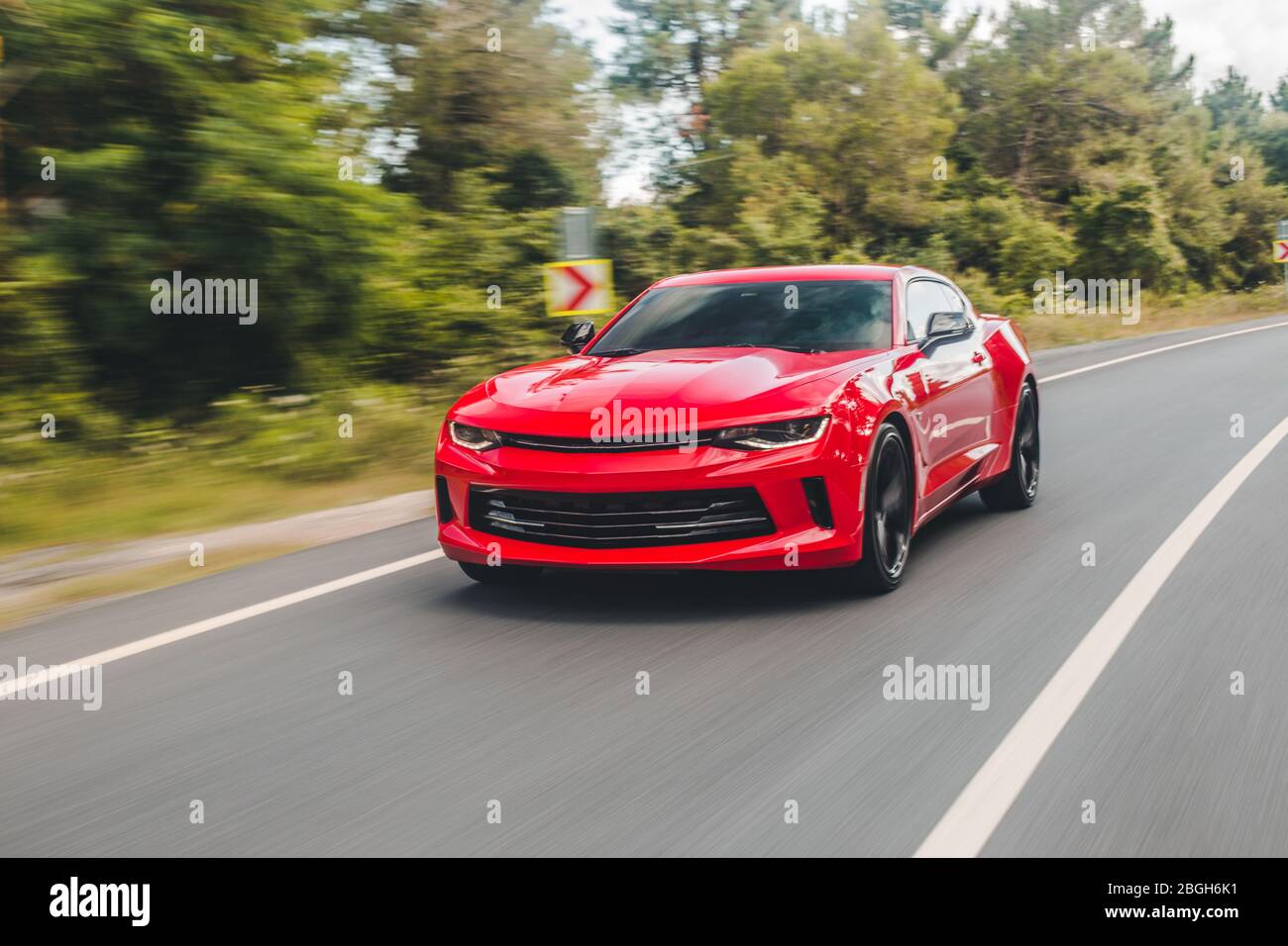 Red modern supercar on the forest road Stock Photo - Alamy