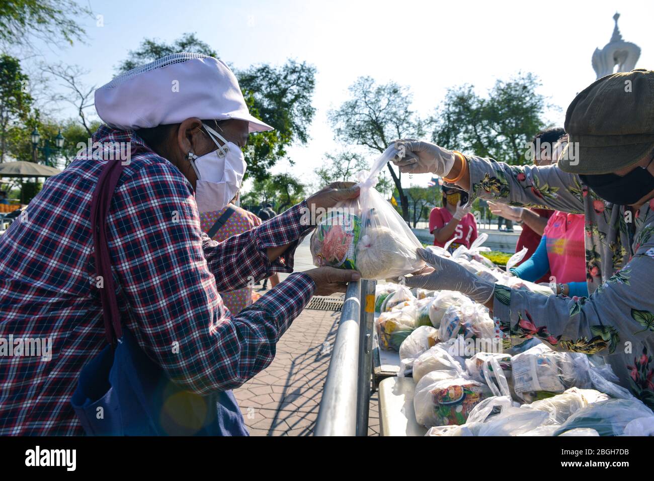 Bangkok, Thailand. 21st Apr, 2020. People give food to pauper homeless ...