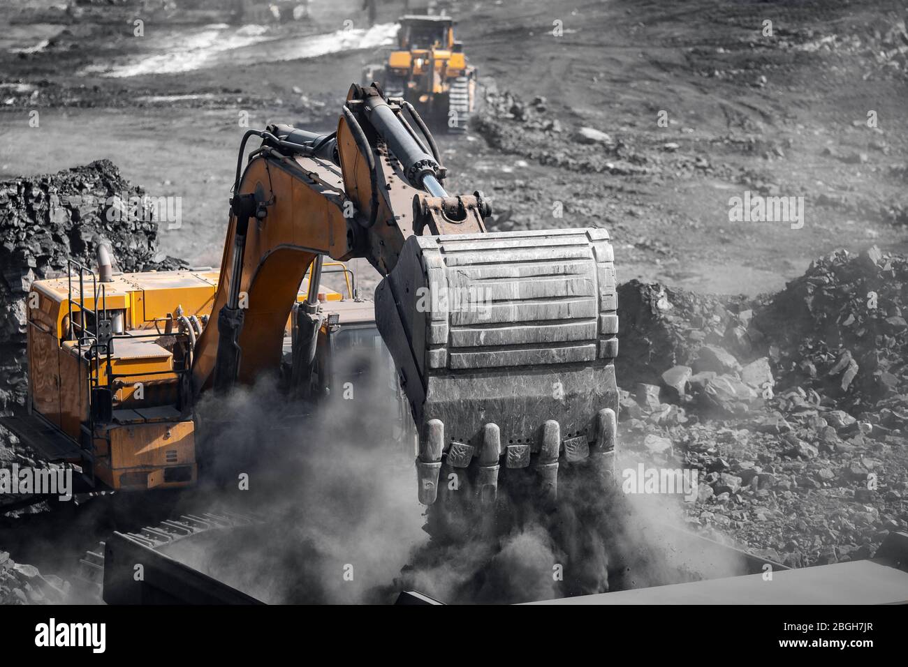 Excavator work loading of coal into Yellow mining truck. Open pit mine ...