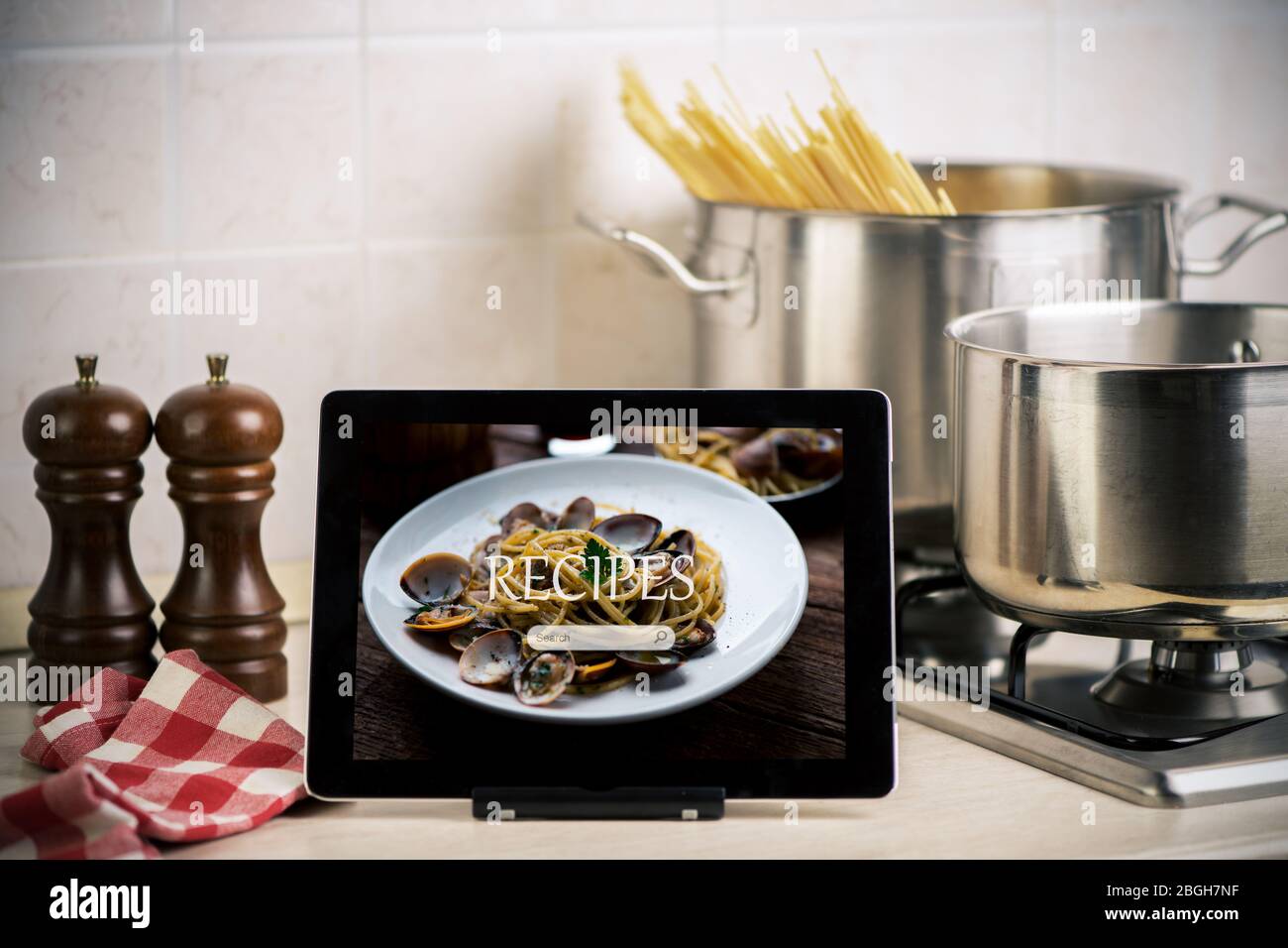 Food recipes tablet computer on rustic wooden table. Pasta Spaghetti ...