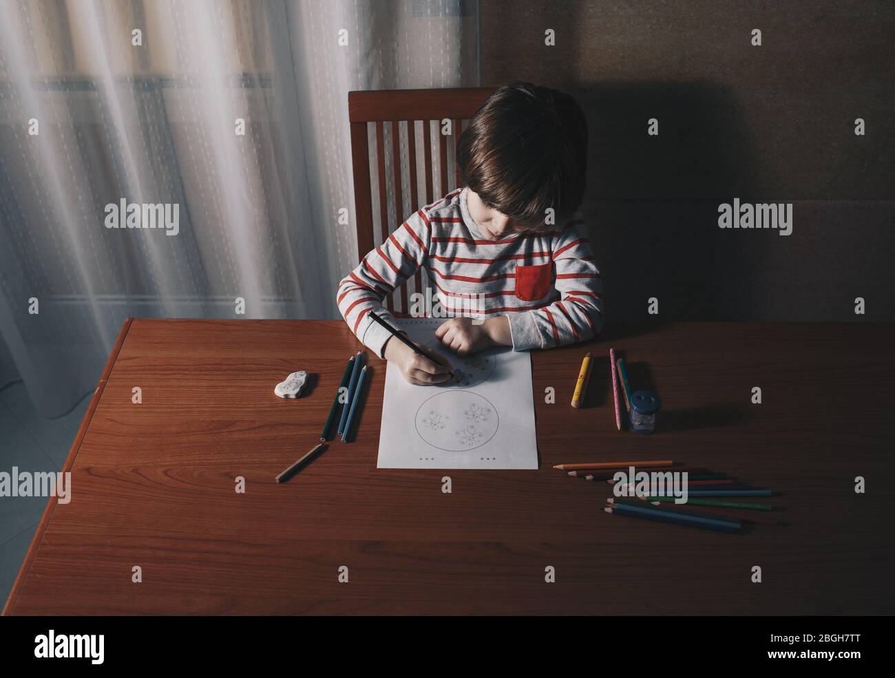 Little boy drawing on the table in his home seen fro above Stock Photo ...