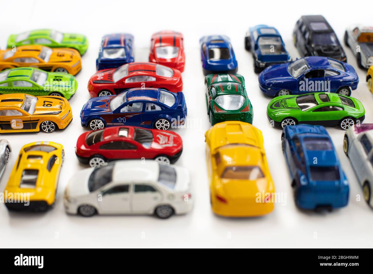 Toy cars of different colors arranged on a white background Stock Photo ...