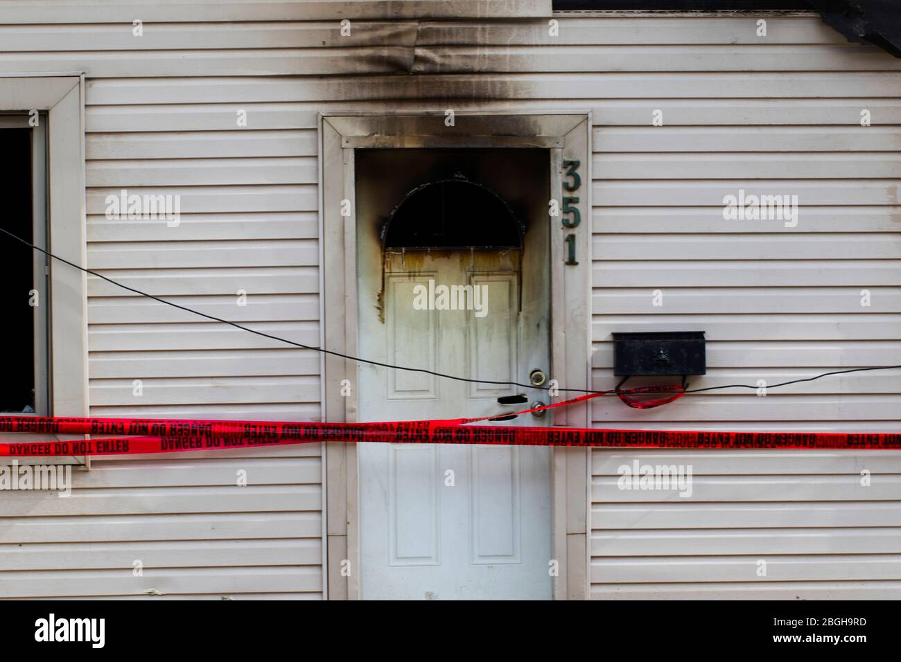 Door damaged by house fire close up arson remains. Home burnt down by ...