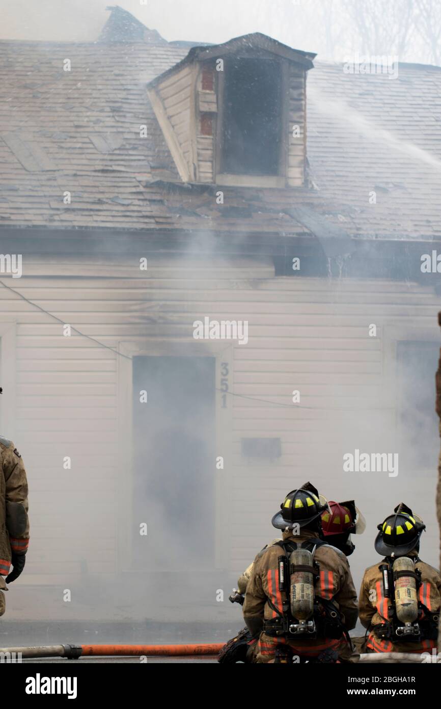 Ontario, Canada April 20 2020:Putting out roof fire with water hose ...