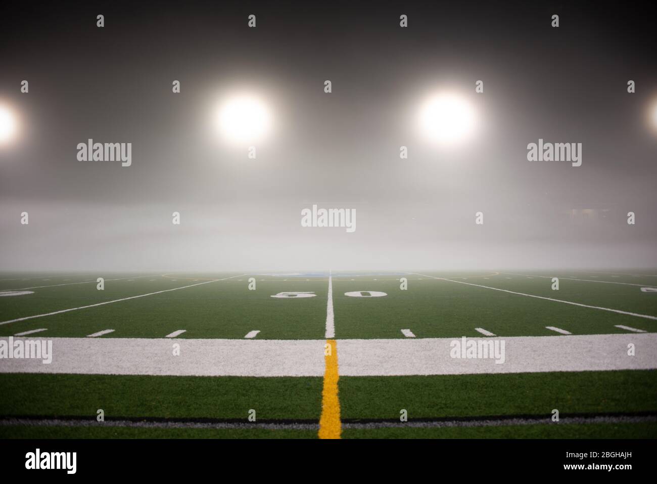 The green grass field of football field in the fog hi-res stock ...